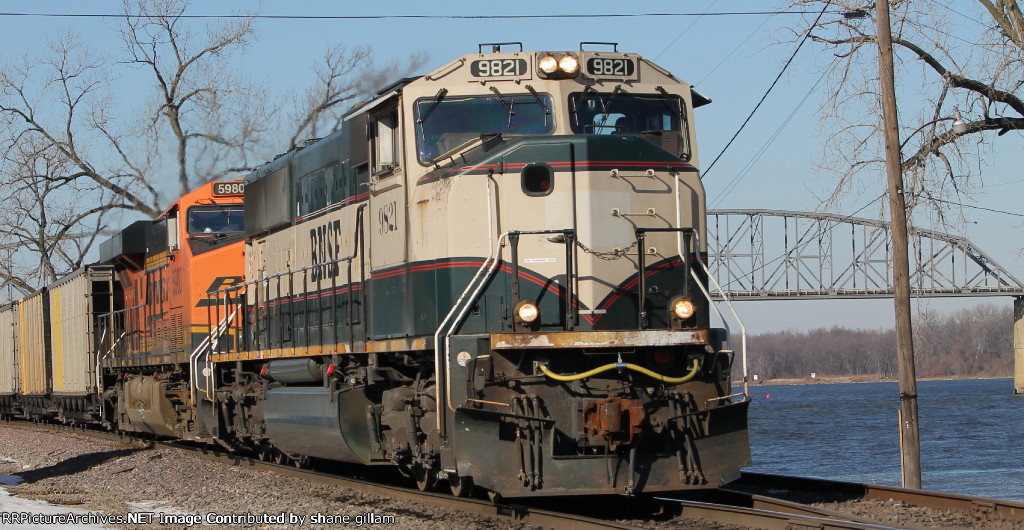 BNSF 9821 rocks coal next to the mississippi